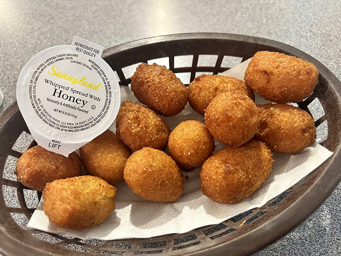 Hush puppies so perfectly golden they deserve their own spotlight. These cornmeal spheres of joy are what bread baskets dream of becoming when they grow up.
