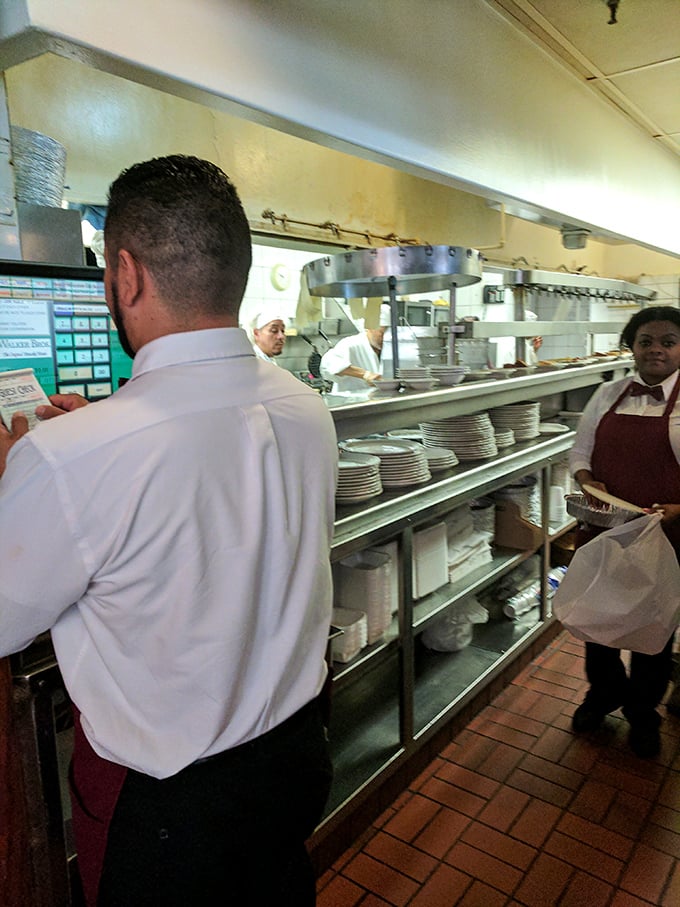 Behind the scenes, the kitchen ballet unfolds – skilled hands turning simple ingredients into morning masterpieces with practiced precision.