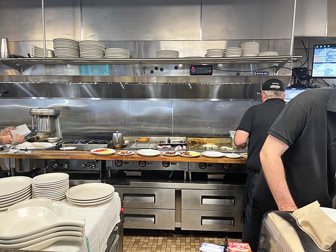 The kitchen ballet in full swing—where short-order choreography turns simple ingredients into the breakfast masterpieces that keep locals coming back.