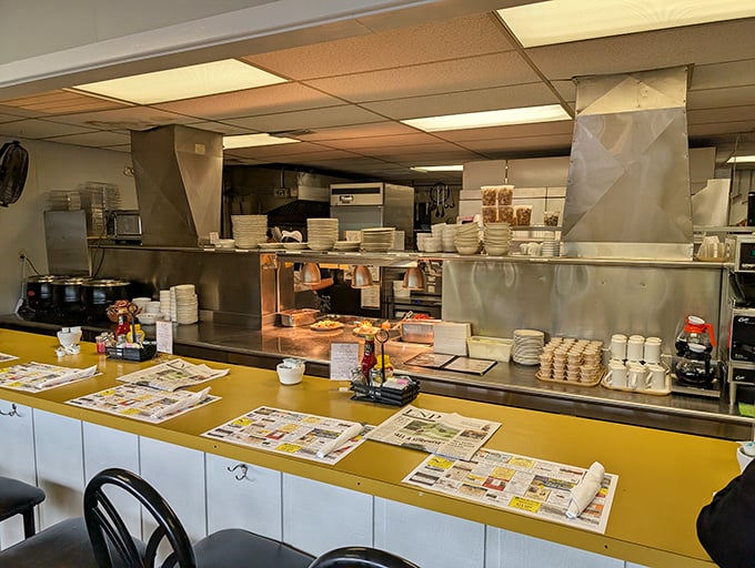 The pass window offers a glimpse into the organized chaos where comfort food masterpieces are born one plate at a time.