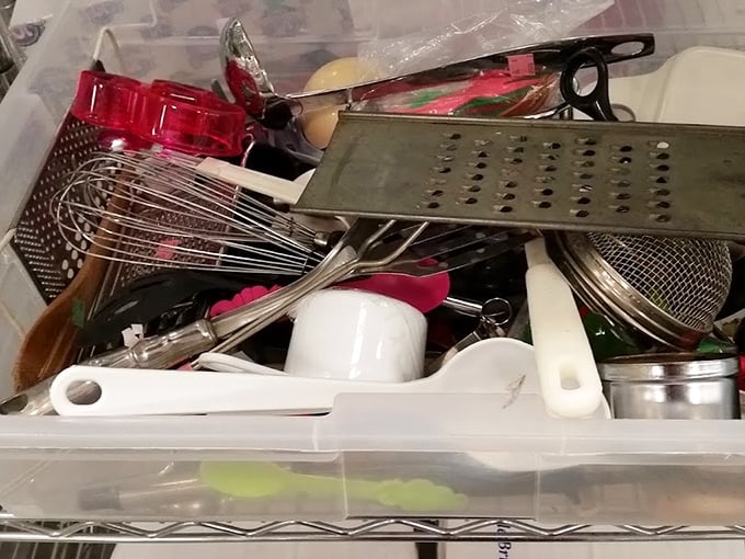 Kitchen drawer chaos, neatly organized – whisks, graters and gadgets whose purposes remain mysterious even to experienced cooks.