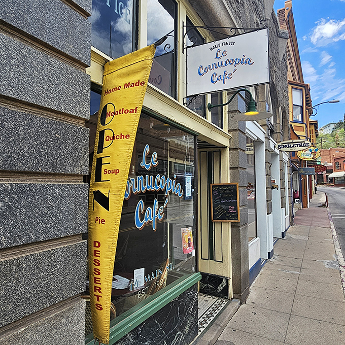 Le Cornucopia Café's charming sidewalk presence promises homemade comfort food that would make your grandmother both proud and slightly jealous.