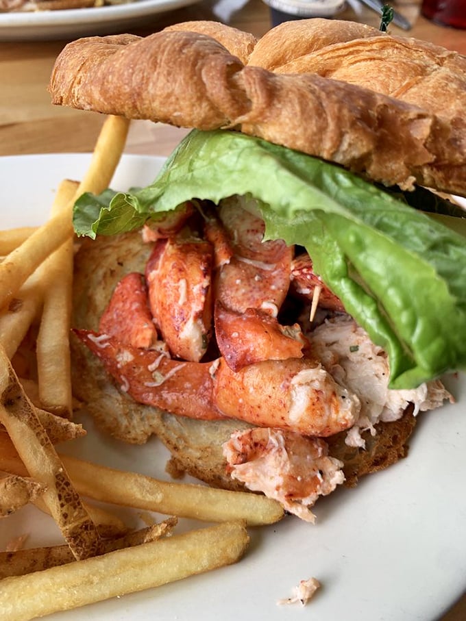 The lobster croissant sandwich—where New England tradition meets French pastry in a romance that would make Nicholas Sparks reach for his notebook.