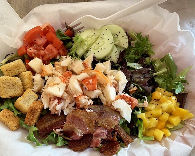 This lobster salad isn't just healthy—it's a colorful party where mango, bacon, and crustacean are the guests of honor. Even the croutons dressed up.