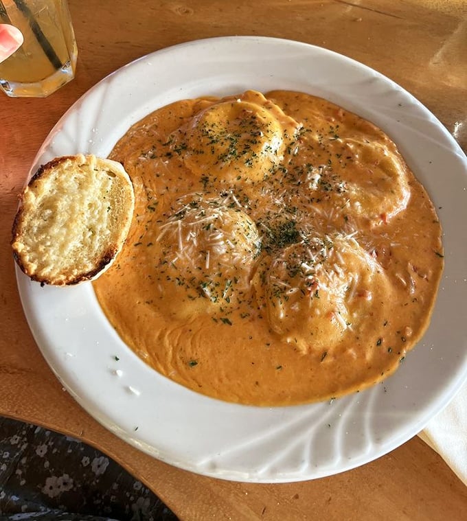 Lobster ravioli swimming in a sunset-colored cream sauce—pasta pillows filled with treasures from the deep that make you want to dive right in.