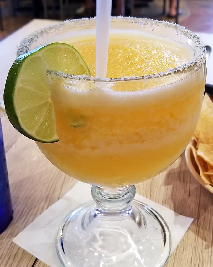 The margarita glass—half the size of your head, twice the fun of ordinary drinks. That lime isn't garnish; it's a necessary vitamin supplement.