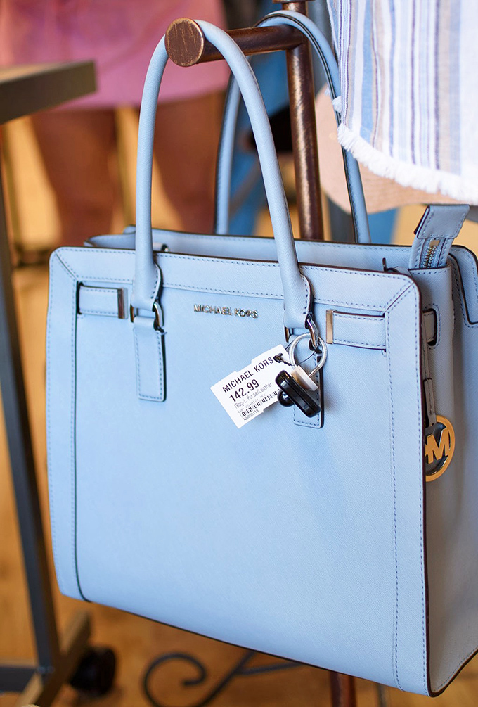 That perfect powder-blue Michael Kors isn't just a bag—it's your next conversation starter, confidence booster, and organizational savior.