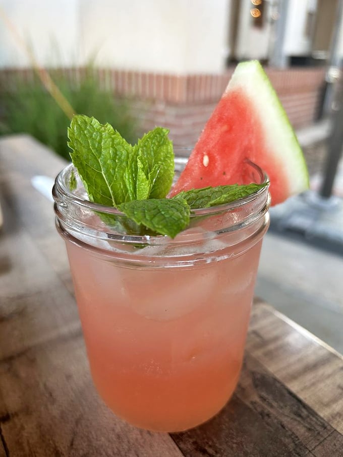 A watermelon cocktail garnished with mint – summer in a glass that whispers, "Yes, you can be refreshed while eating half your weight in brisket."