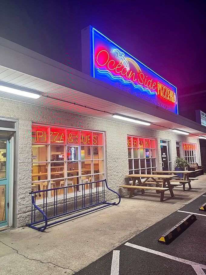 Oceanside Pizza's neon glow beckons hungry beachgoers after dark. Nothing tastes quite like pizza after a day of salt air and sunshine.