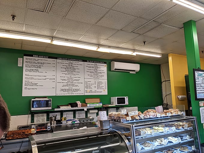 Green walls, white menus, and a bakery case that beckons—Barry's ordering area is where breakfast dreams begin.
