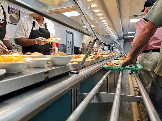 The serving line – where dreams come true and diets go to die – showcases a rainbow of Southern sides waiting for their moment of glory.