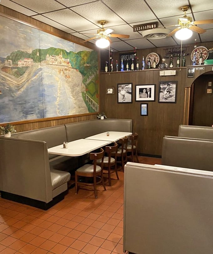 The wood-paneled walls and cozy booths create an atmosphere where time slows down and conversations flow as freely as the wine.