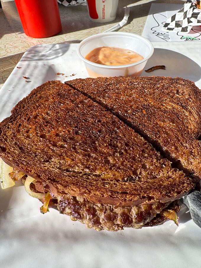 The patty melt – that glorious marriage of burger and grilled cheese – arrives on rye with caramelized onions playing matchmaker.