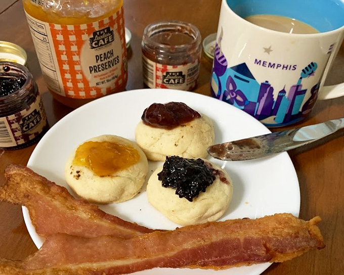 Biscuits so light they might float away if not anchored by preserves. Three different jams and country ham – breakfast paradise on a simple white plate.