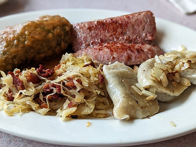 A plate that screams "Old World comfort"—pierogi, kielbasa, and sauerkraut creating a symphony of flavors that would make any Polish grandmother nod in approval.