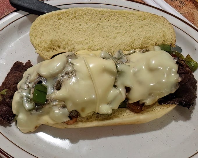 The ribeye sandwich doesn't whisper its presence—it announces itself with melted cheese and tender meat on a pillowy bun.
