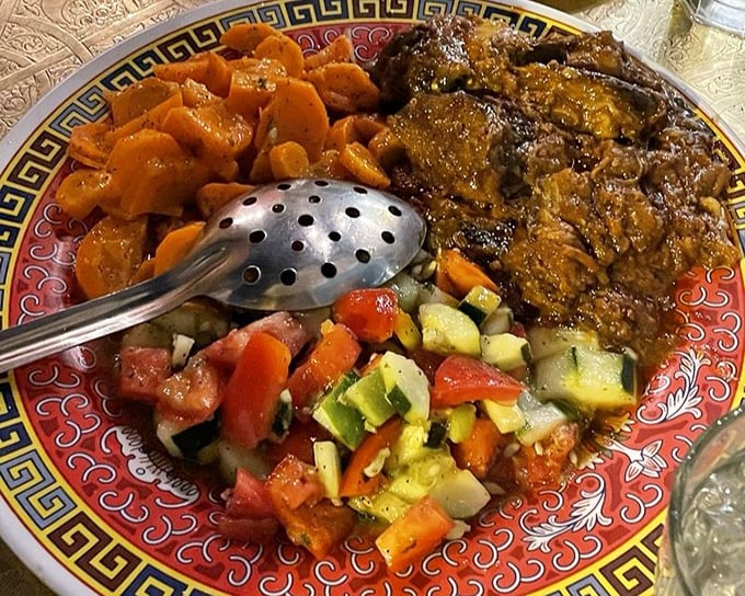 A trio of vibrant salads shares plate space with succulent meat—proof that Moroccans understood the perfect balance of flavors long before "balanced eating" became trendy.