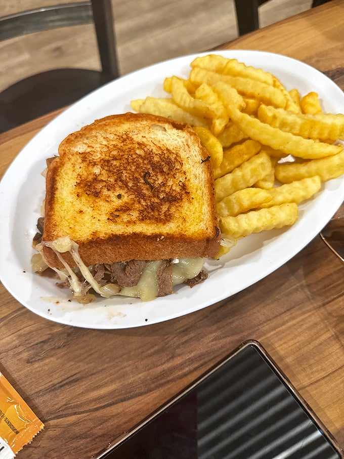 That patty melt on grilled bread with waffle fries is what happens when lunch decides to get serious about satisfaction.