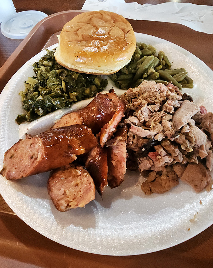 The barbecue sampler of your dreams – sausage, pulled pork, greens, and a bun that's ready to soak up every last drop.