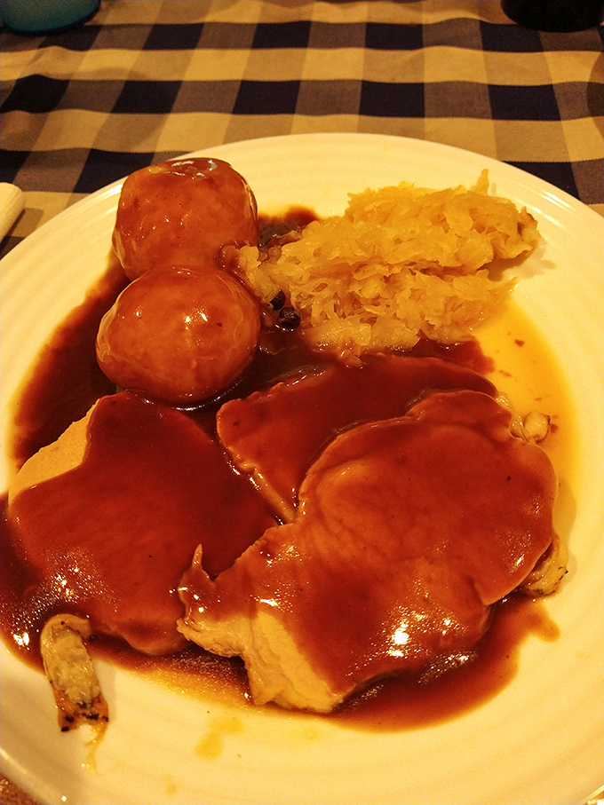 Schweinebraten with potato dumplings and sauerkraut—the kind of meal that makes you want to yodel with joy, even if you've never yodeled before.