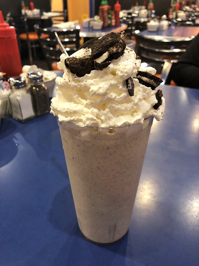 This cookies-and-cream shake isn't just a beverage – it's a dessert skyscraper with whipped cream penthouse and cookie crumble rooftop garden.