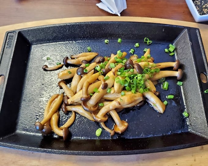 Shimeji mushrooms sizzling on a hot plate – nature's little umami bombs exploding with earthy goodness.