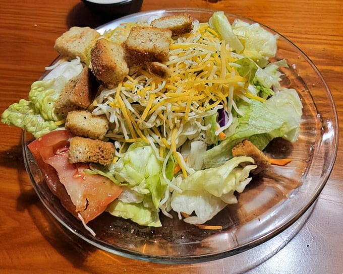 A fresh garden salad that doesn't apologize for being exactly what it is—the virtuous prelude to the glorious indulgence that follows.