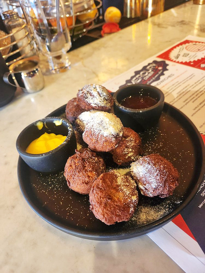 These "Space Balls" aren't from a Mel Brooks movie, but they're equally memorable—warm, sweet fritters dusted with powdered sugar and served with dipping sauces.