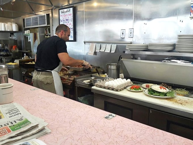 The kitchen ballet—where eggs are cracked with one hand and orders are remembered without writing them down. True professionals at work.