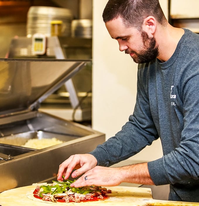 Behind every great pizza is a dedicated craftsman, carefully assembling each pie with the precision of a Swiss watchmaker and the soul of an artist.