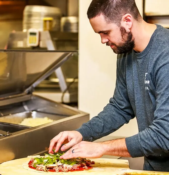 Behind every great pizza is a dedicated craftsman, carefully assembling each pie with the precision of a Swiss watchmaker and the soul of an artist.