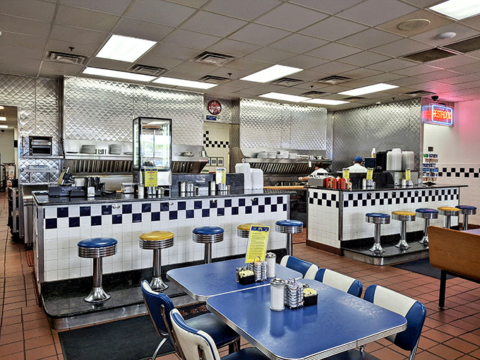 The counter view—where diner magic happens. Those diamond-pattern walls have witnessed countless coffee refills and life-changing breakfast decisions.