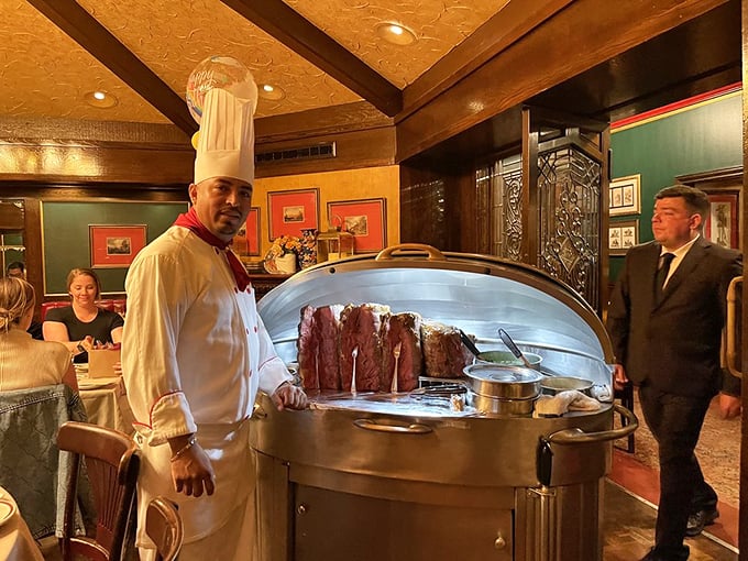 The silver meat cart approaches – dinner theater at its finest. This moment of tableside carving is worth the price of admission alone.
