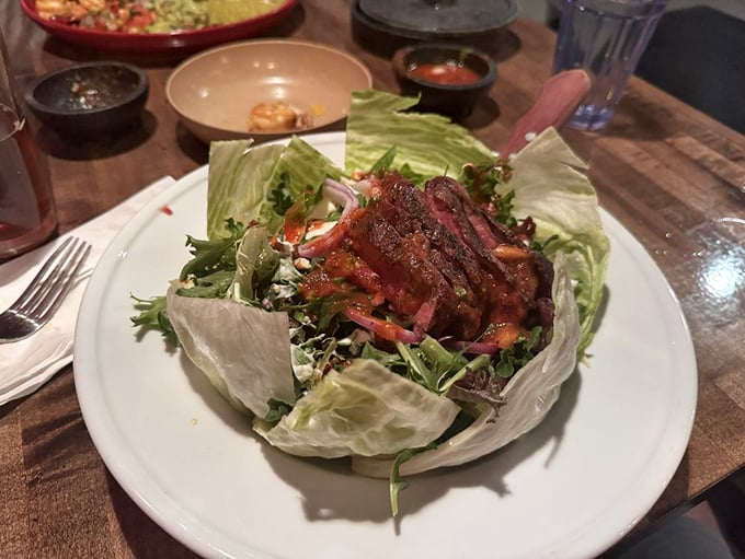 Perfectly seared steak crowning a mountain of fresh greens—proof that salads can absolutely be worth the calories.