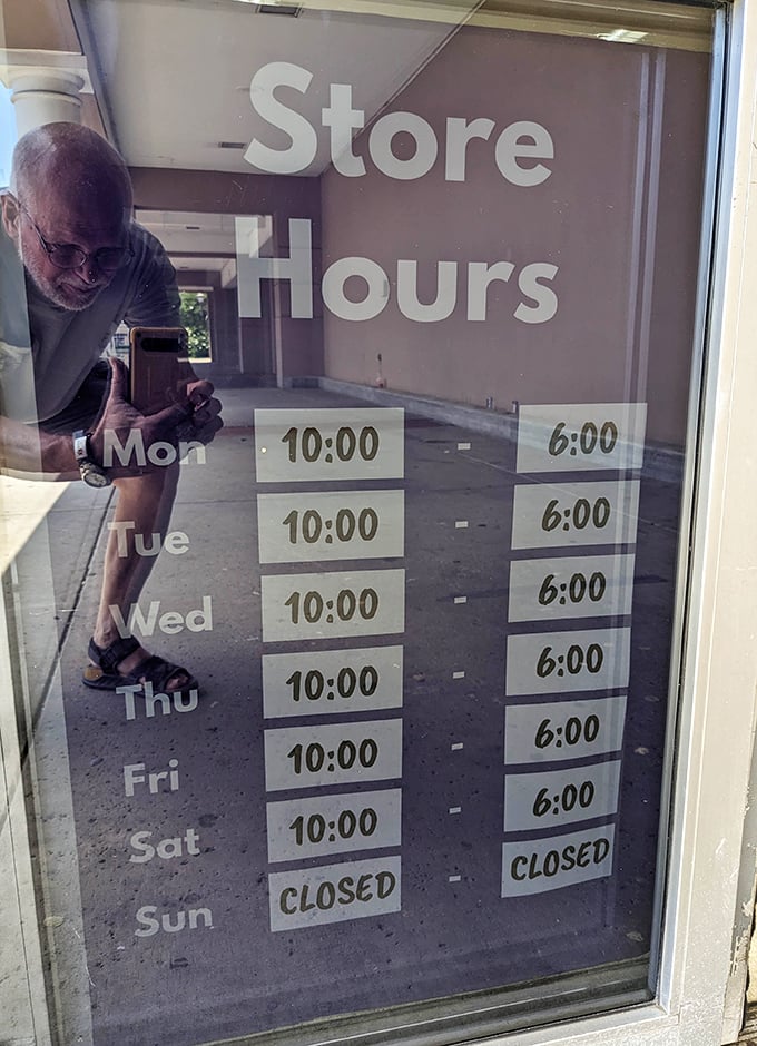 Store hours posted clearly—because knowing when to hunt for treasures is half the battle in the thrifting game.