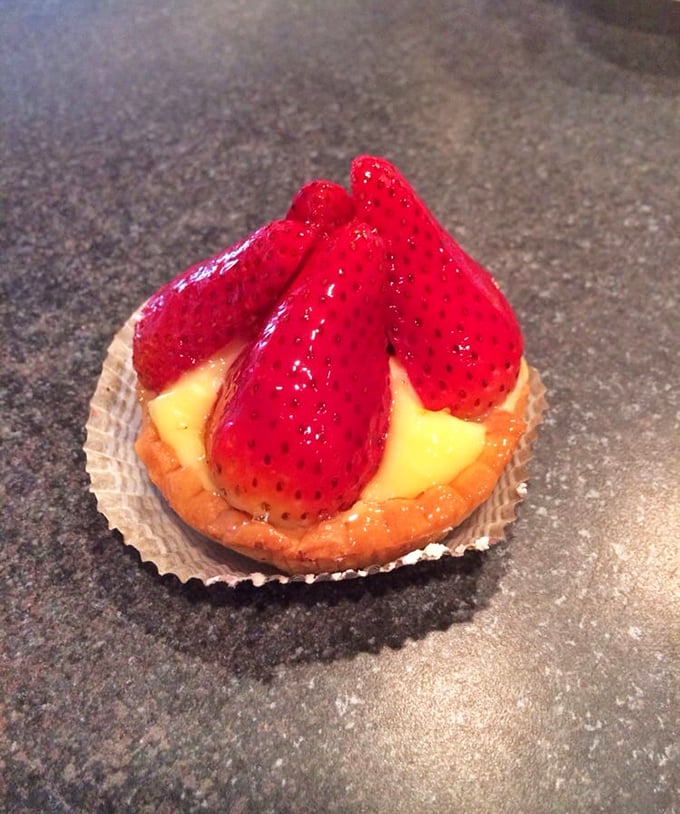 This strawberry tart isn't just dessert; it's nature and craftsmanship having a beautiful conversation on a plate.