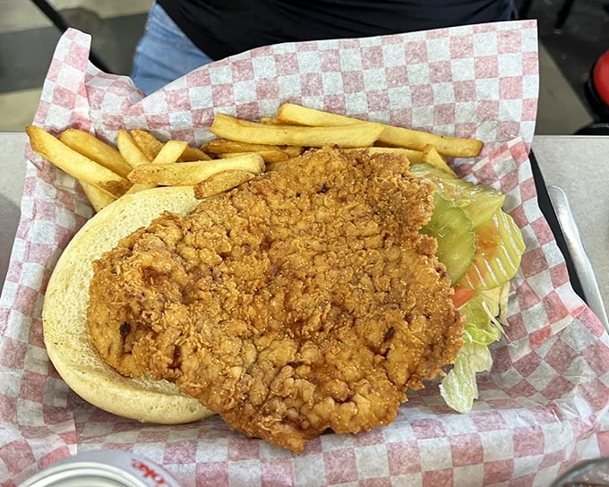 The tenderloin sandwich and fries represent Indiana comfort food at its finest—golden, crispy, and substantial enough to fuel a factory shift.