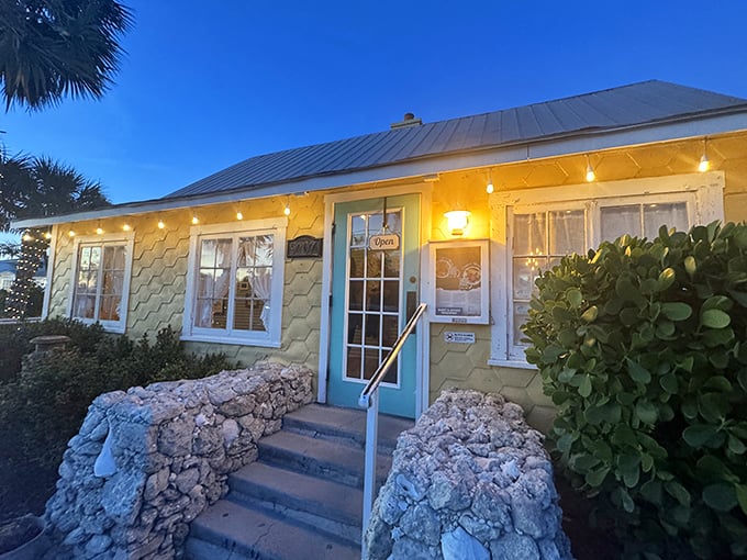 The Porch Restaurant glows with island charm at dusk – its honeycomb-yellow exterior as warm and inviting as the meals served inside.