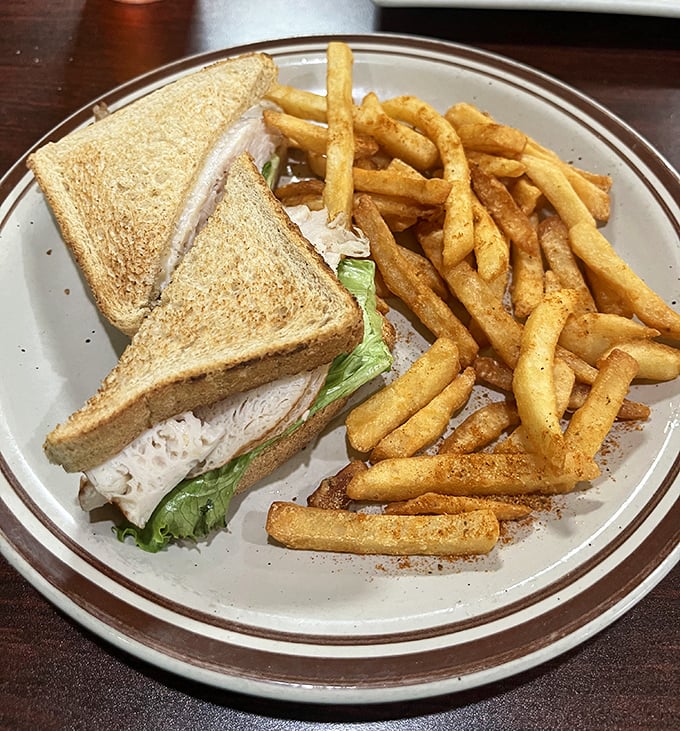 A classic turkey sandwich with crispy fries—sometimes the simplest pleasures are the most satisfying, especially on diner-quality bread.