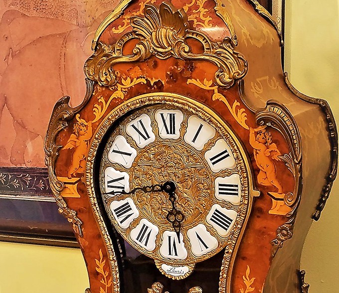 This ornate clock doesn't just tell time—it tells stories. With its intricate woodwork and regal face, it's practically royalty in furniture form.