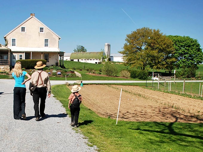 Three generations walking the same path—literally and figuratively—as farming wisdom passes down with each step toward the fields.