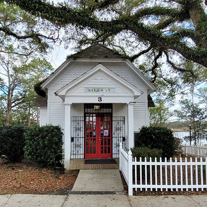 The Walton-DeFuniak Library's quaint white cottage and red door invite you into a world where books still smell like adventure.