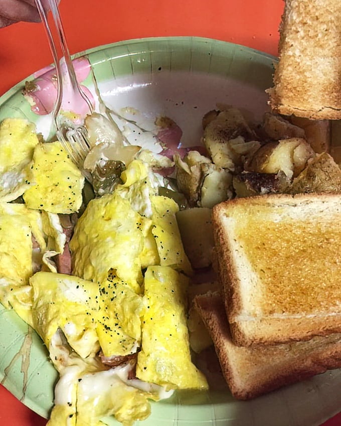 A western omelet that would make any diner proud – fluffy eggs folded around ham and vegetables, with toast standing by for clean-up duty.