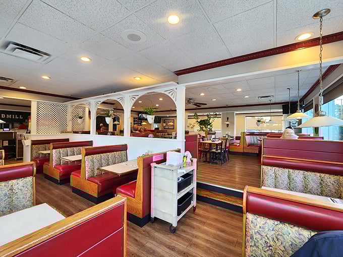 Architectural details like white lattice dividers and red booths create distinct dining zones while maintaining that classic American diner feel we all crave.