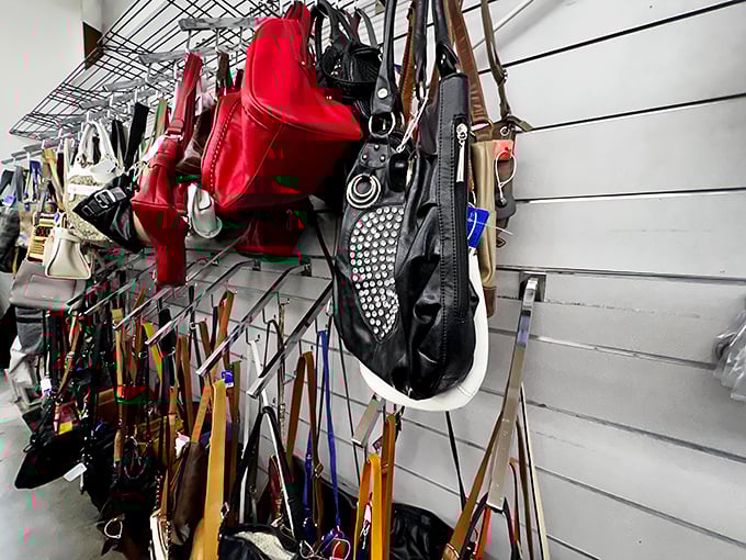The handbag wall – a leather and vinyl tapestry where designer knockoffs hang alongside genuine vintage finds. The red one is practically winking at you.
