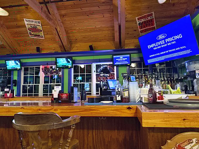The bar area combines rustic charm with modern convenience – cold drinks and warm atmosphere under those beautiful wooden beams.