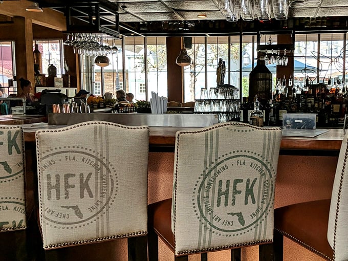 The bar stools aren't just comfortable—they're front-row seats to the mixology magic that turns Florida moonshine into sophisticated Southern cocktails.
