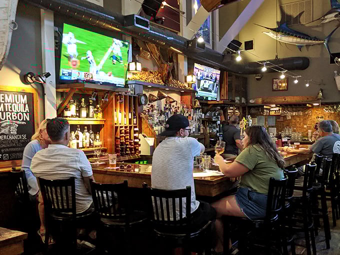 The bar at Striper Bites—where strangers become friends and friends become regulars. Those bourbon bottles aren't just decoration—they're liquid possibilities.