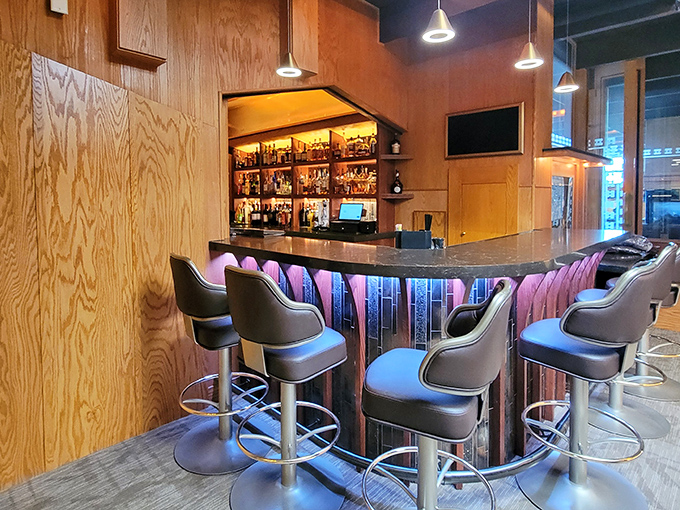 The bar glows with promise and premium spirits—a mid-century modern altar where Wisconsin's brandy religion is practiced nightly.