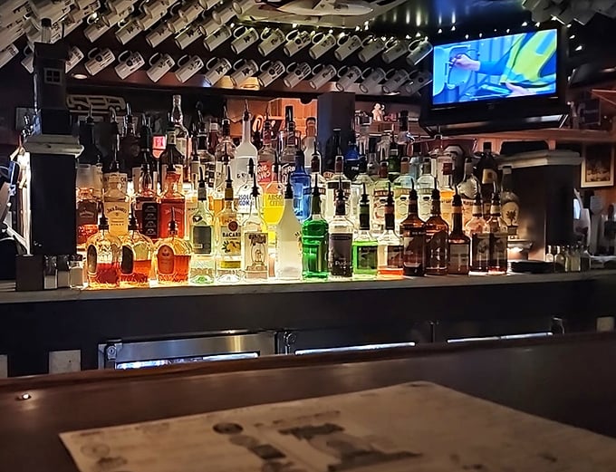The well-stocked bar glows with amber bottles—liquid treasures waiting to complement your burger adventure.